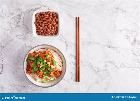 Shan Noodles With Peanuts And Chopsticks At White Marble Tabletop