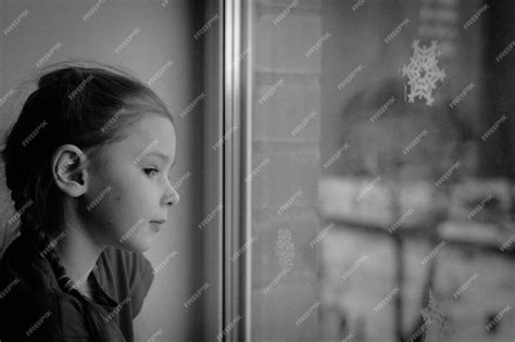 Premium Photo Portrait Of Girl Looking Through Window