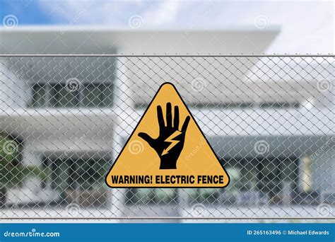 An Electric Fence Warning Sign In Front Of A House A Caution Signage
