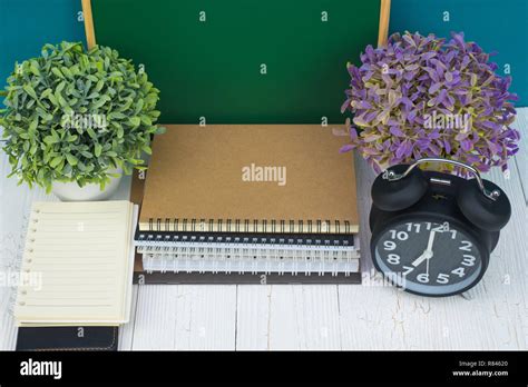 Back To School And Education Concept Idea Green Chalkboard With Pile Of Notebook Paper Back To School And Education Concept Idea Green Chalkboard With Pile Of Notebook Paper