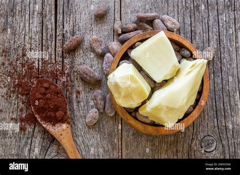 Cocoa Butter Or Cocoa Bean Solid Oil And Raw Cocoa Beans On Rustic Backdrop Healthy Natural Oil