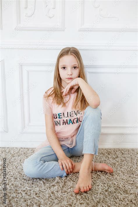 Cute Pre Teen Girl Wearing Fashion Clothes Posing In White Interior
