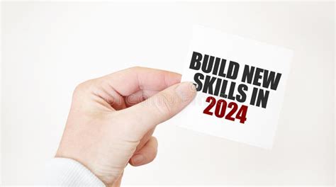Businessman Holding A Card With Text Build New Skills In 2024 Business