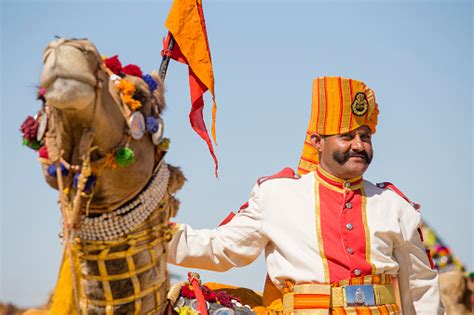 전통적인 Rajasthani 드레스를 입고 낙 타 및 인도 남자 Jaisalmer Rajasthan 인도에 사막 축제의 일환으로
