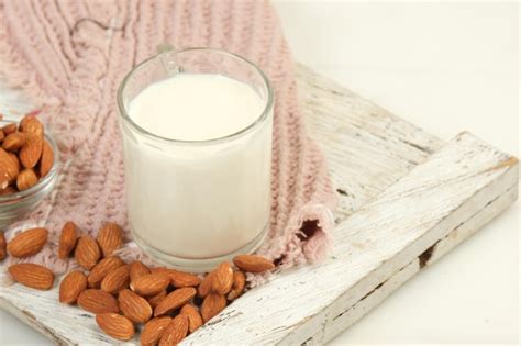 Premium Photo A Glass Of Almond Milk With Almond On Light Background