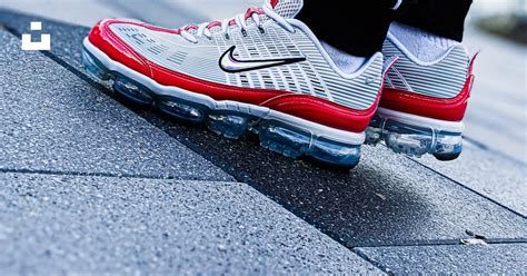 Person Wearing Black White And Red Nike Athletic Shoes Photo Free
