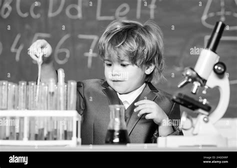 Small Boy Using Microscope At Lesson Microscope At Lab Back To School