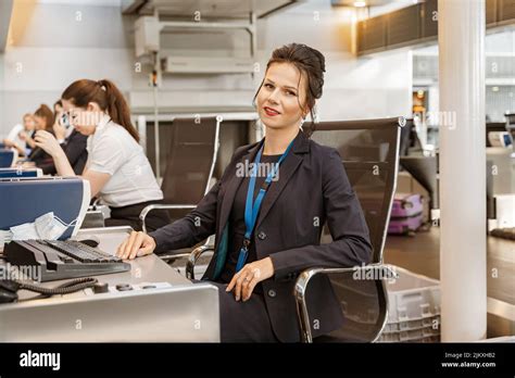 Woman Airline Employee Working At Airline Check In Counter In Airport