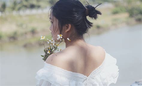 Lady Wearing White Spaghetti Strap Top And Holding Her Brown Short Hair