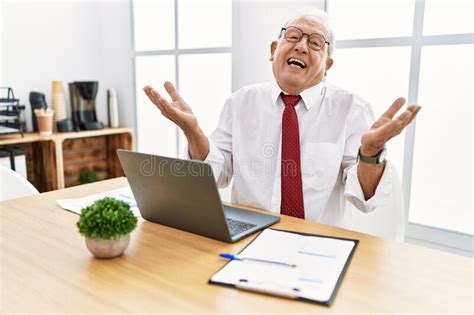 Senior Man Working At The Office Using Computer Laptop Smiling Cheerful