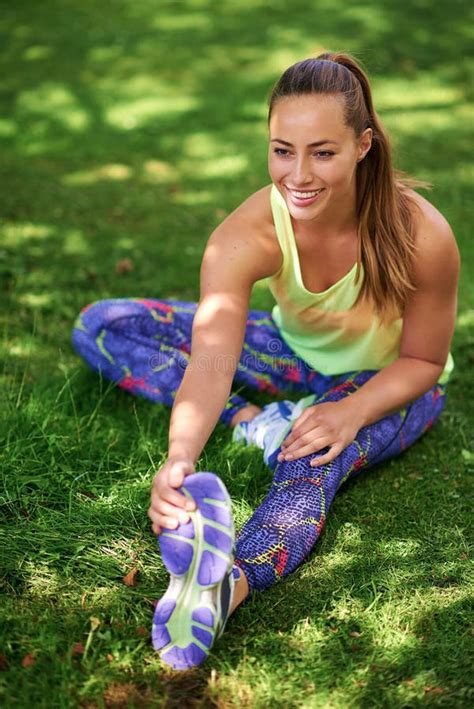 Outdoor Fitness And Smile Of Woman Stretching And Workout In Grass Of