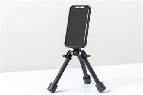 Small Flexible Tripod With Mobile Phone Holder Isolated On The White