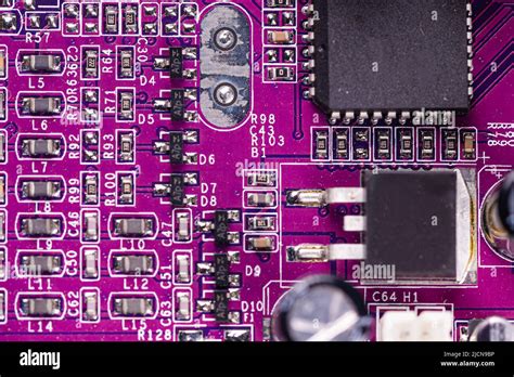 Macro Close Up Shot Of Microchip On Red Printed Circuit Board Computer Motherboard With