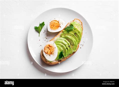 Avocado Toast With Hard Boiled Eggs On White Background Top View