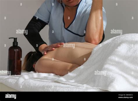Young Woman Receiving A Relaxing Back Massage From A Professional