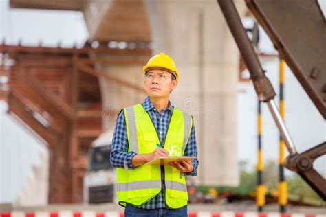 Engineer Checking Project At The Building Site Man In Hardhat With Clipboard Checklist At The