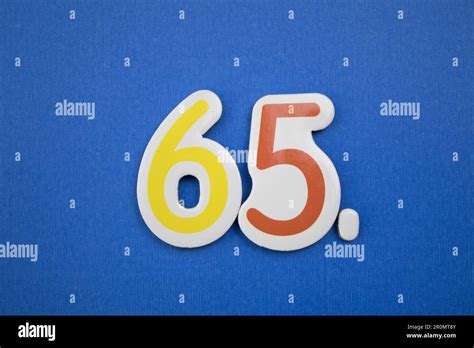 The Number 65 Placed On A Blue Background Photographed From Above Colored Yellow And Red