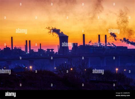 steel factory at sunset causing pollution smoke global warming issue