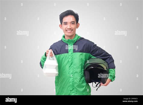 Portrait Of Asian Online Taxi Driver Wearing Green Jacket And Helmet