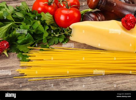 Raw Italian Spaghetti Heap With Cheese And Vegetables Stock Photo Alamy