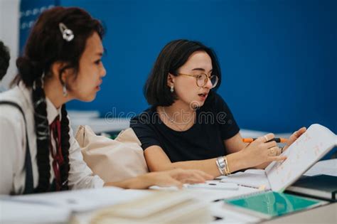 Students Collaborating On Class Tasks With Assistance From Professor