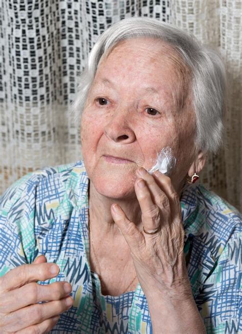Old Woman Applying Anti Aging Cream Stock Photo Image Of Skin Senior