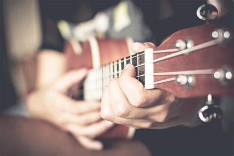 Premium Photo Close Up Of Man Playing String Instrument