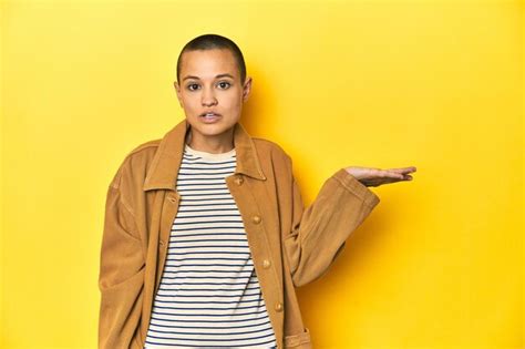 Premium Photo Woman In Striped Tee And Denim Shirt Yellow Backdrop