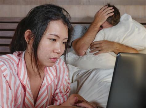 Frustrated Husband Moody In Bed Ignored By His Workaholic Asian Wife Or
