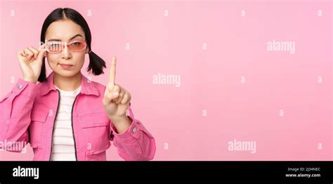 Image Of Asian Girl With Serious Face Showing Prohibit Scolding