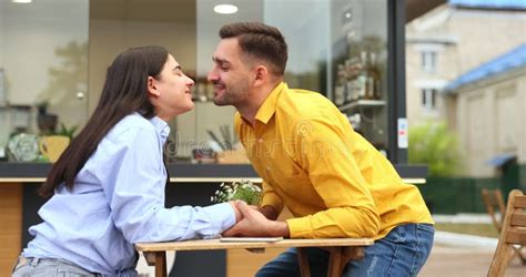 Cute Couple In Front Of The Cafe The Man In The Yellow Shirt Kisses