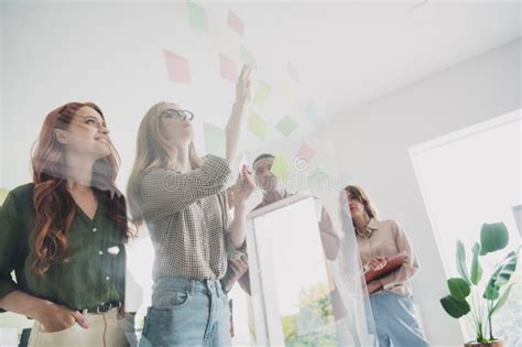 Photo Of All Business Team Members Concentrated Searching Solution Put Stickers On Glass Indoors
