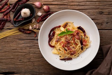 Stir Fried Capellini Pasta With Dried Chili And Crispy Bacon On White