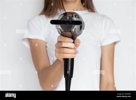 The Girl Dries Her Hair With A Hairdryer On A White Background Hair