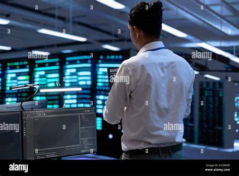Engineer Using Tablet To Troubleshoot Hardware And Software Issues In Server Hub It Specialist