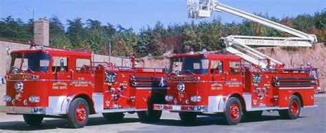 Two Red Fire Trucks Parked Next To Each Other