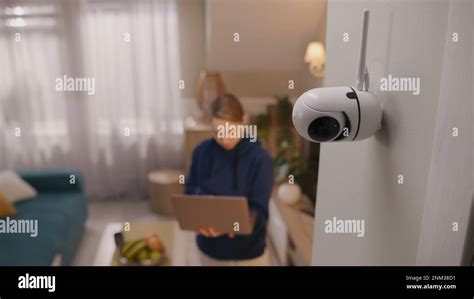 Caucasian Woman Installs Security Camera Woman Sets Up Angle Of Cctv