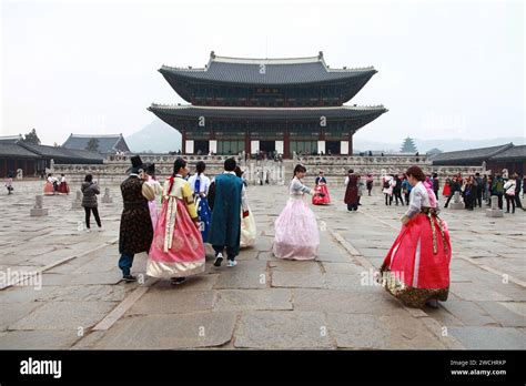 People Wearing Traditional Hanbok Costumes At The Gyeongbokgung Palace