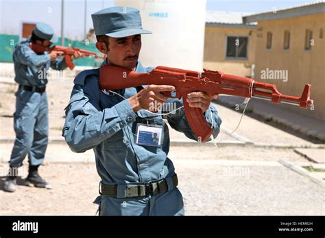 Two Afghan Uniform Police Recruits Hold Their Rubber Ak 47 Assault