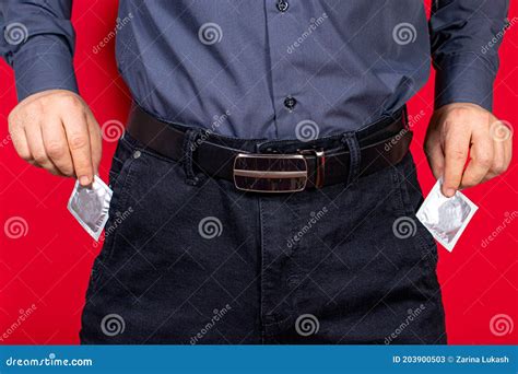 A Man Pulls Out Two Condoms From His Pocket Barrier Method Of