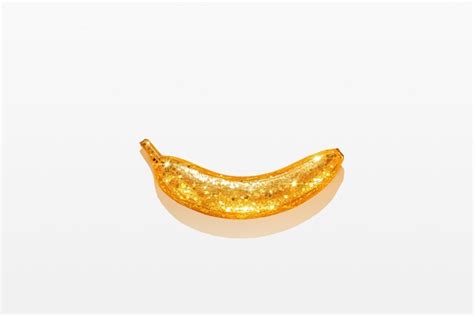 Premium Photo Creative Golden Banana With Glitter On White Background