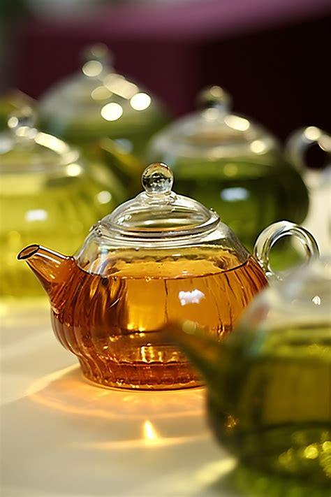 Teapots On A Glass Table Background Wallpaper Image For Free Download