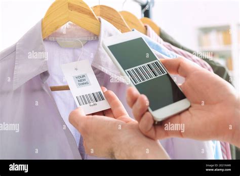 Woman Scanning Bar Code From A Label In A Shop With Mobile Phone Stock Photo Alamy