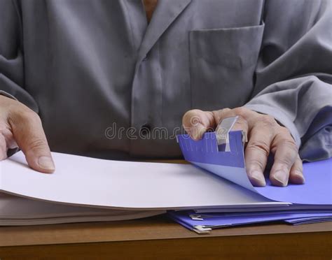 Putting Away Paper In A Folder For Organization Work Order And Future