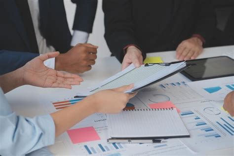 Premium Photo Close Up Of Business Team Analyzing Income Charts And