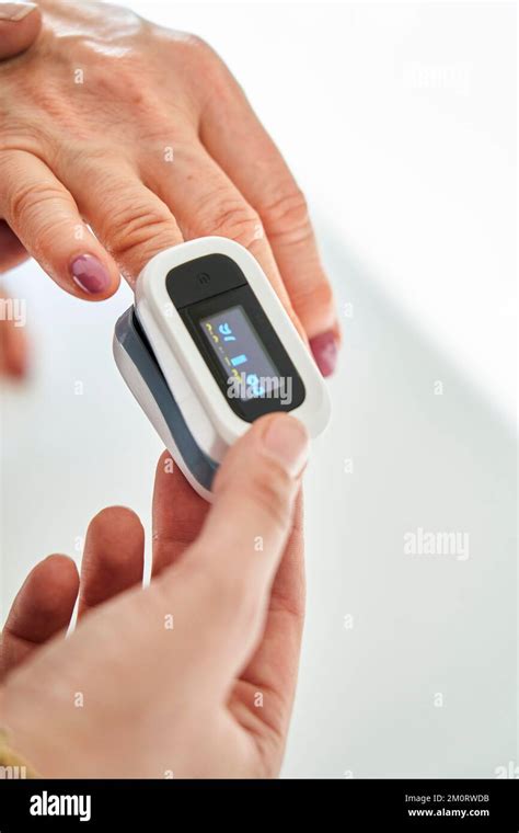 Woman Measuring Oxygen Saturation With An Oximeter Stock Photo Alamy