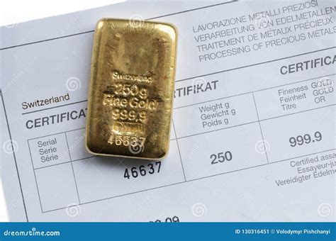 The Certificate Of Assay For Gold Bars Lies On A Cast Gold Ingot Stock
