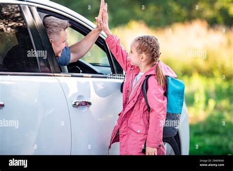 Dad Picks Up His Little Daughter From School In His Car And Gives Her A