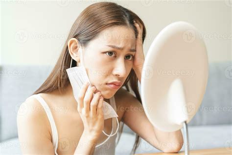 Expression worry asian young woman hand touching pustule around the chin and mouth, allergic ...