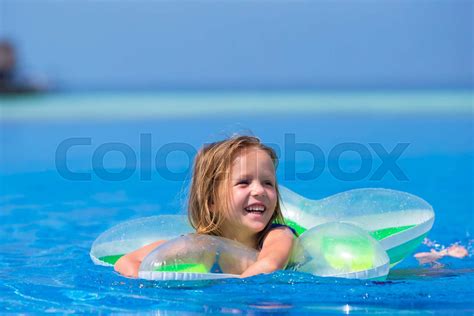 Little Happy Adorable Girl In Outdoor Swimming Pool Stock Image